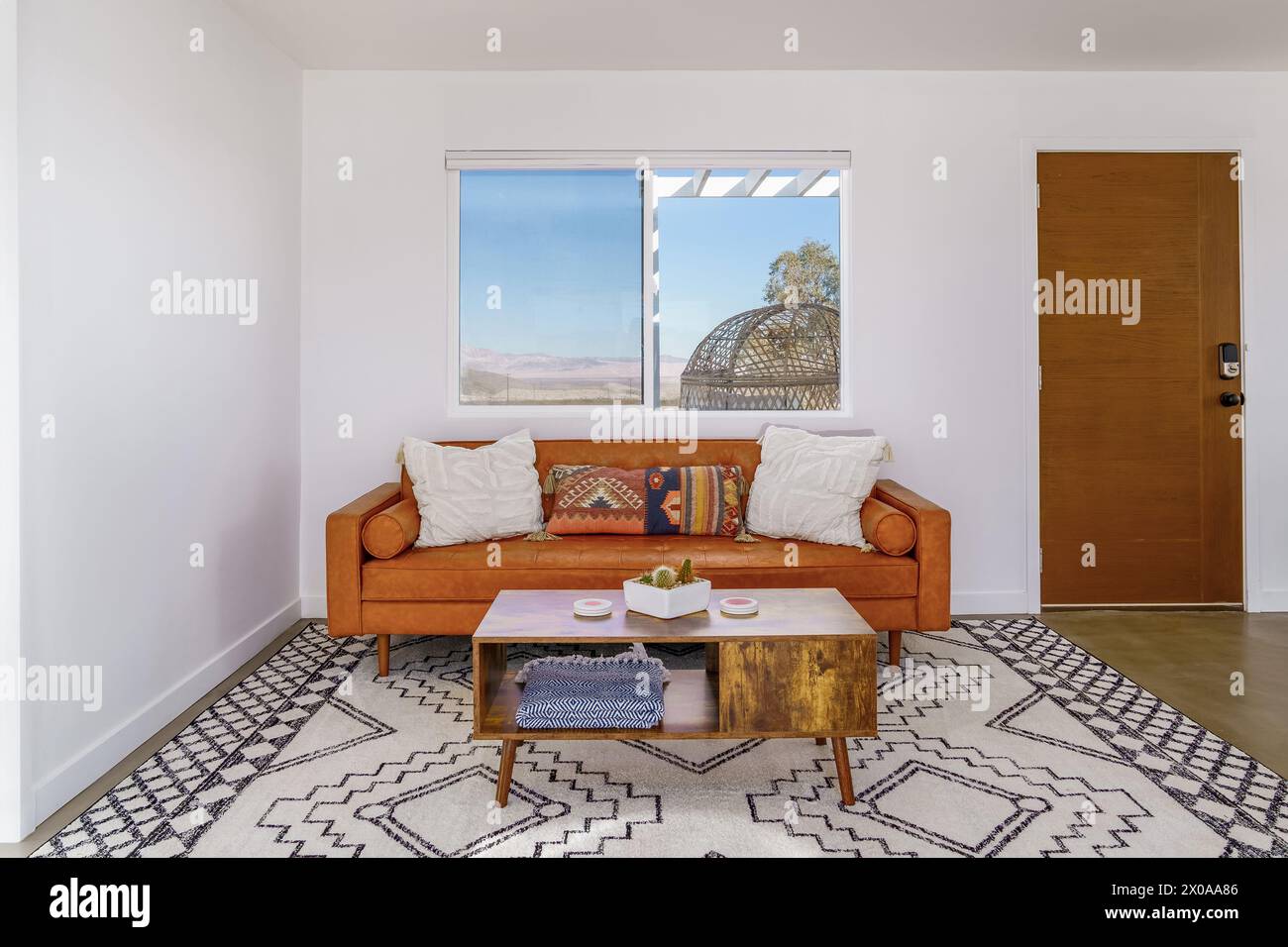 White black living room with leather couch and designer southwest rug ...