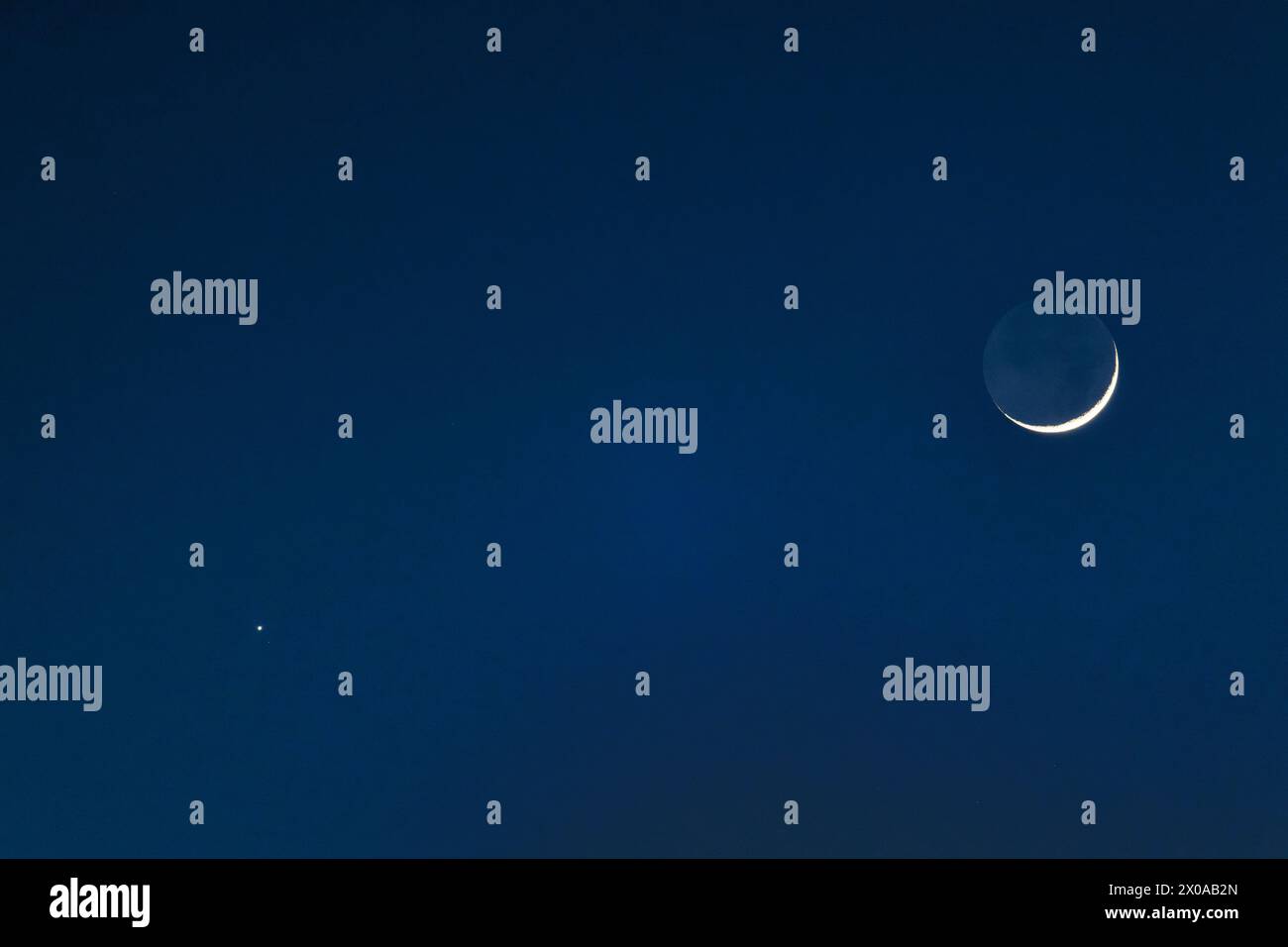 Cologne, Germany. 10th Apr, 2024. The young moon stands as a narrow ...