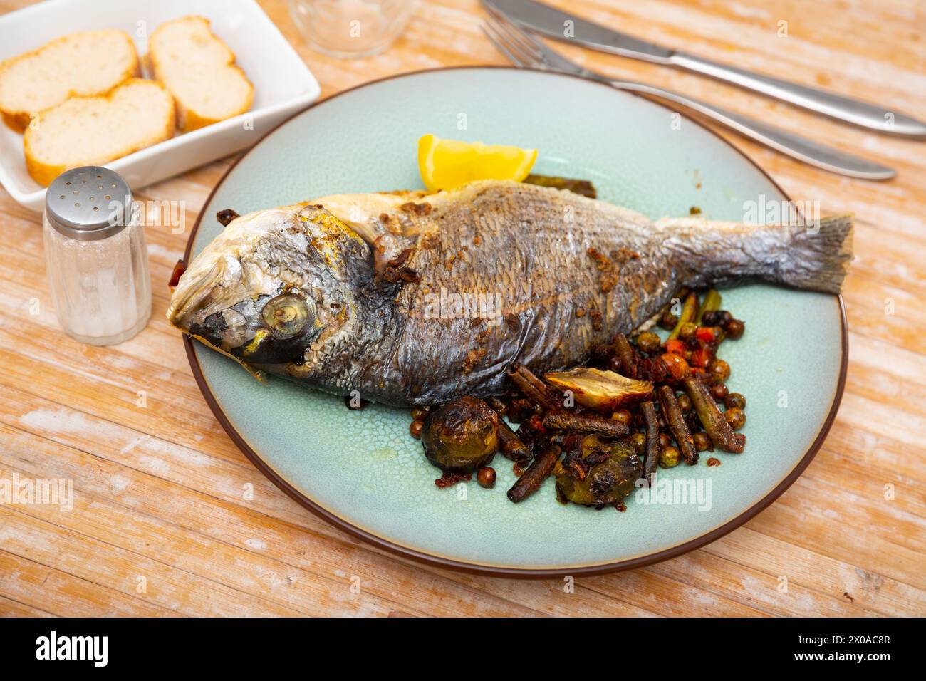 Fried dorada with lemon, baked brussels sprout, green beans, peas and ...