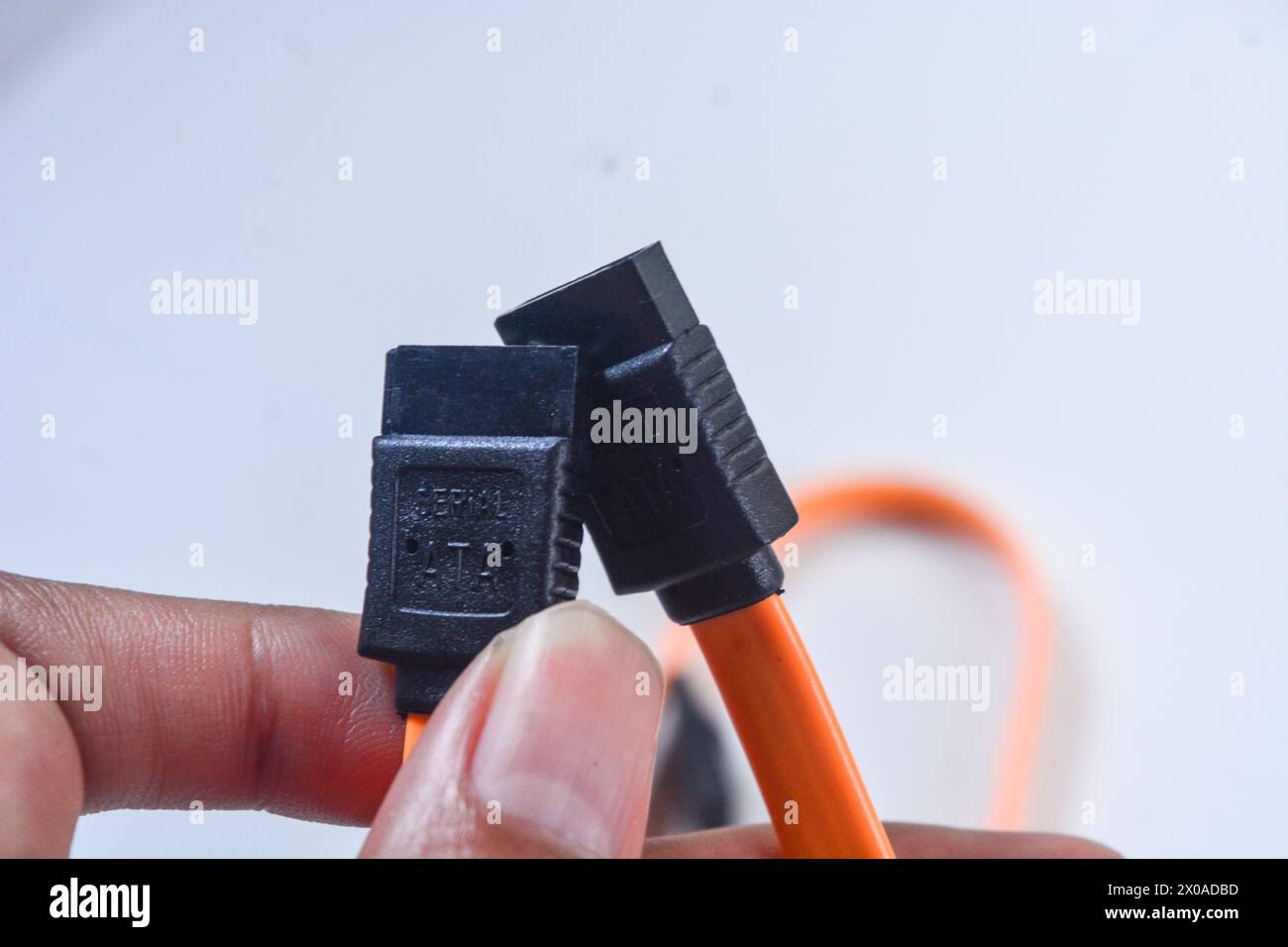 Close up orange Serial ATA(SATA) cable connected to computer ...