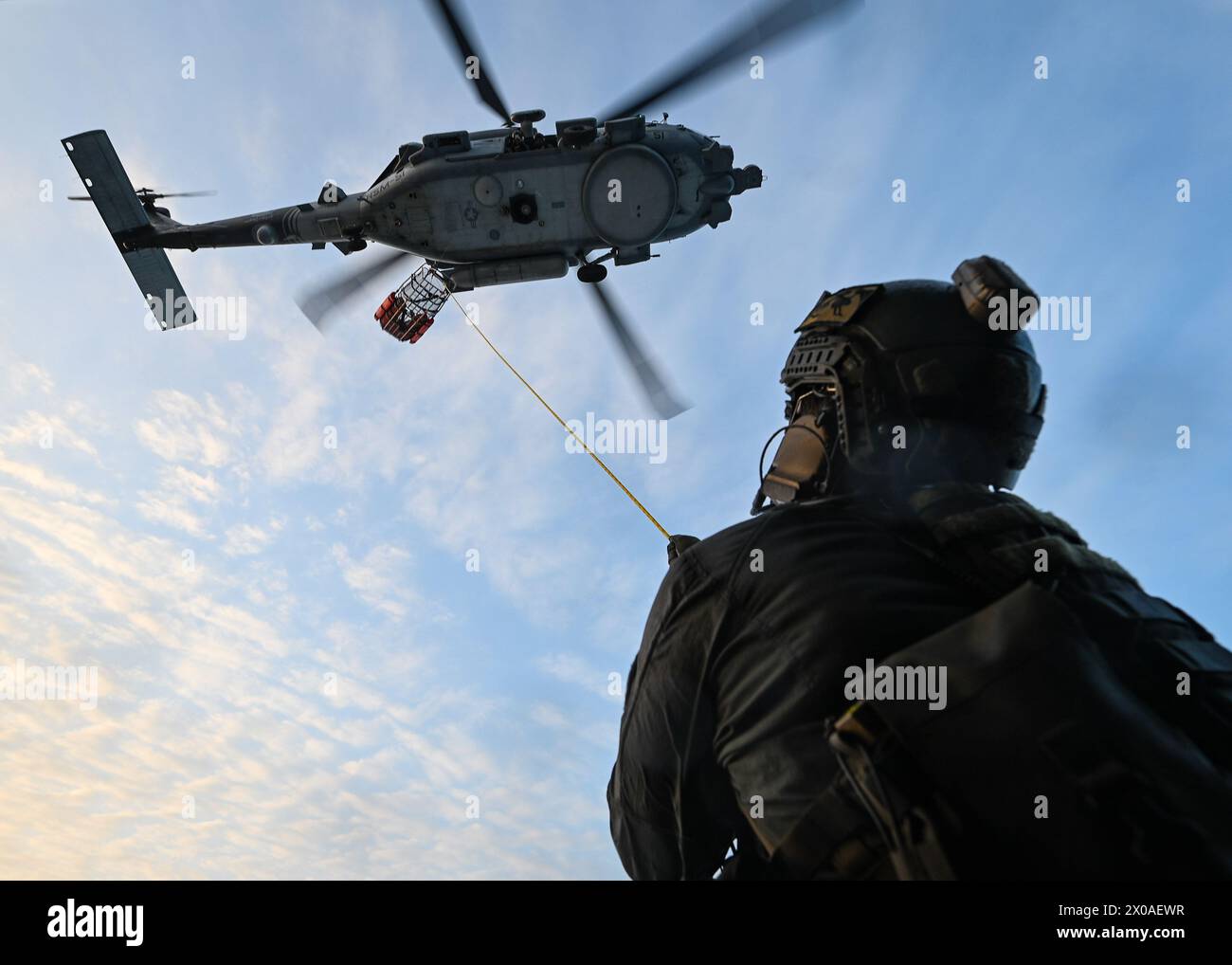 Naval Special Warfare operator guides a litter while conducting ...
