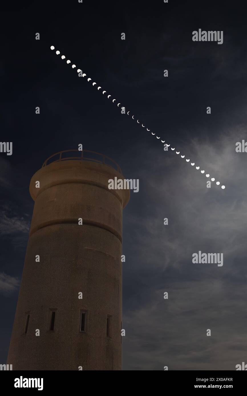 Solar eclipse sequence over World War II watch tower near Gordons Pond ...