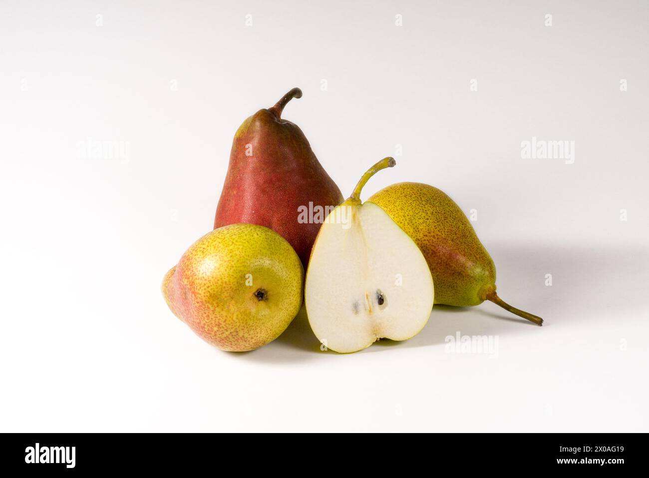 South Africa pears in whole fruit and one cut in half isolated on white ...