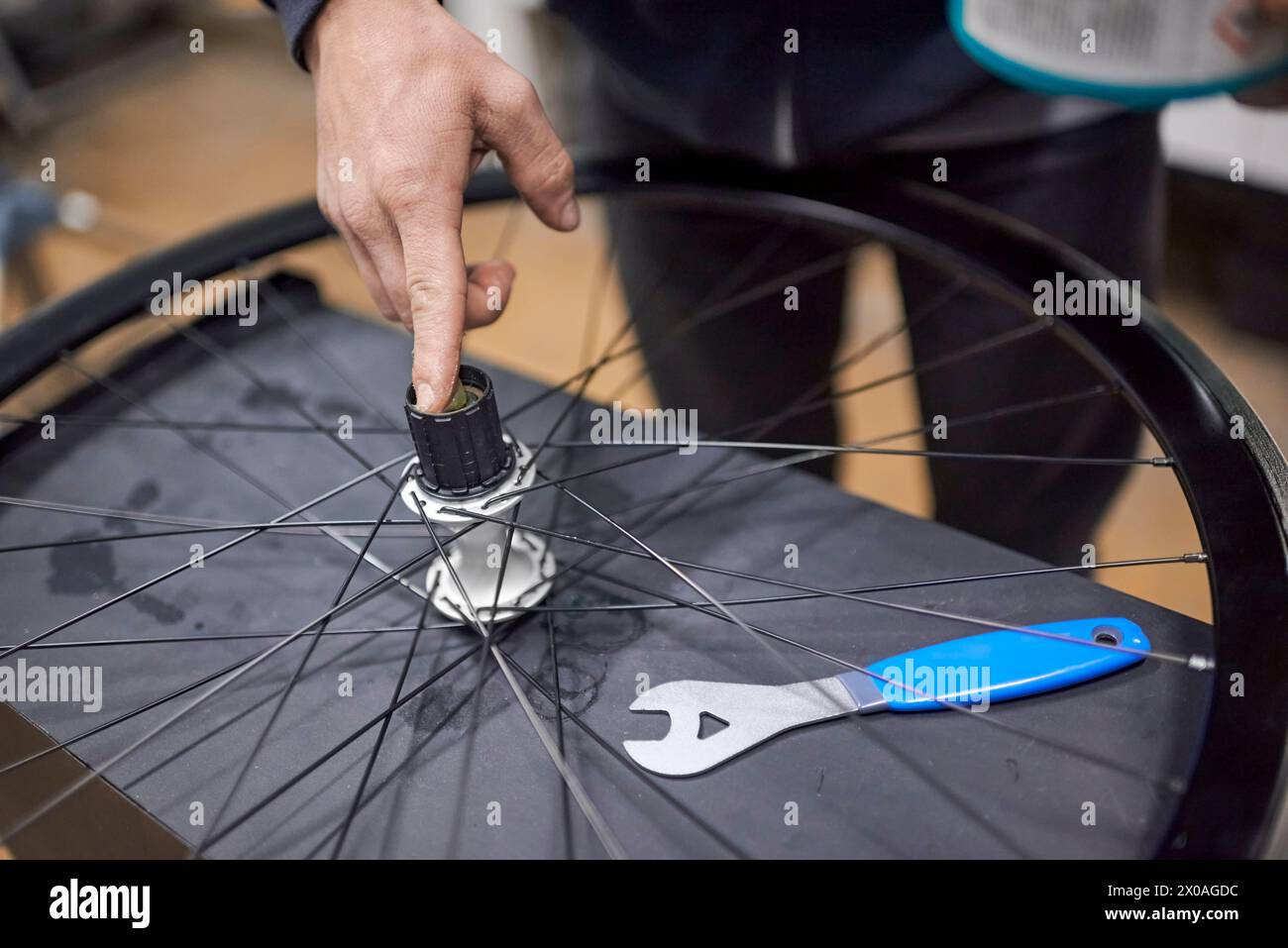 Unrecognizable person greasing the freehub of a bicycle wheel ...