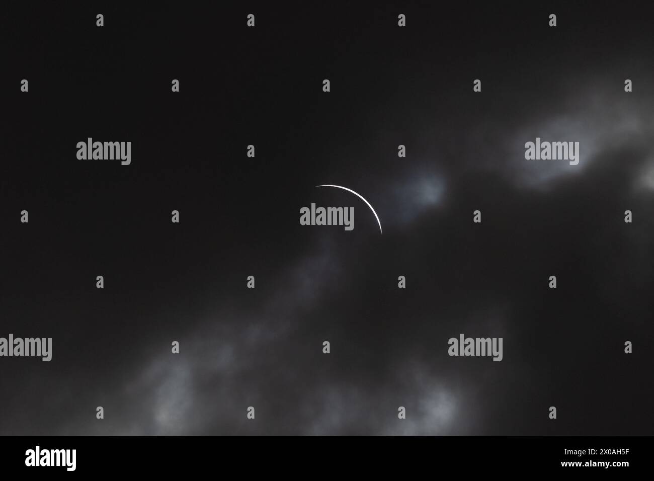 Partial solar eclipse - moon covers sun, dark clouds, celestial drama ...