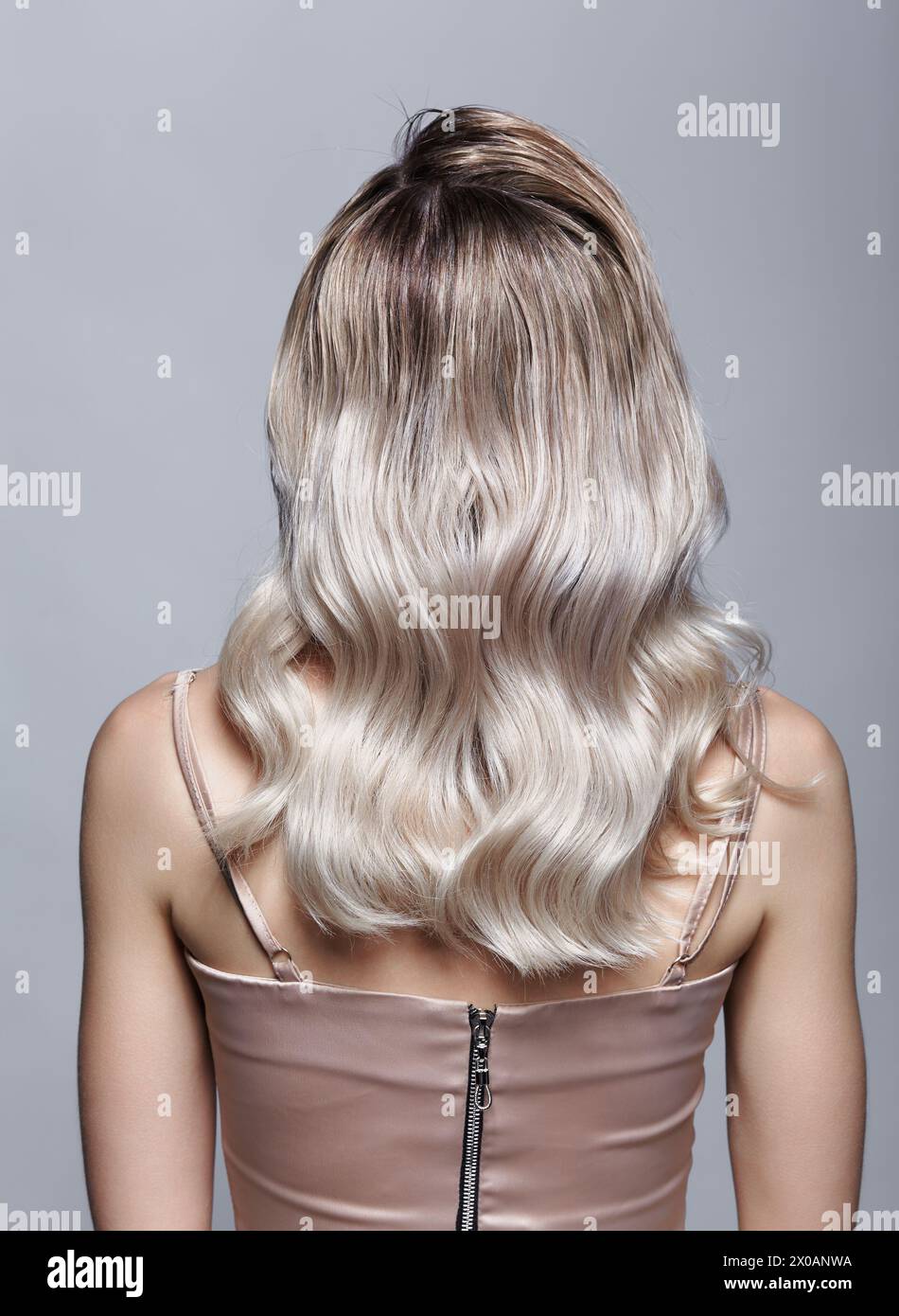 Woman from backside on gray background. Female with long blonde hair ...