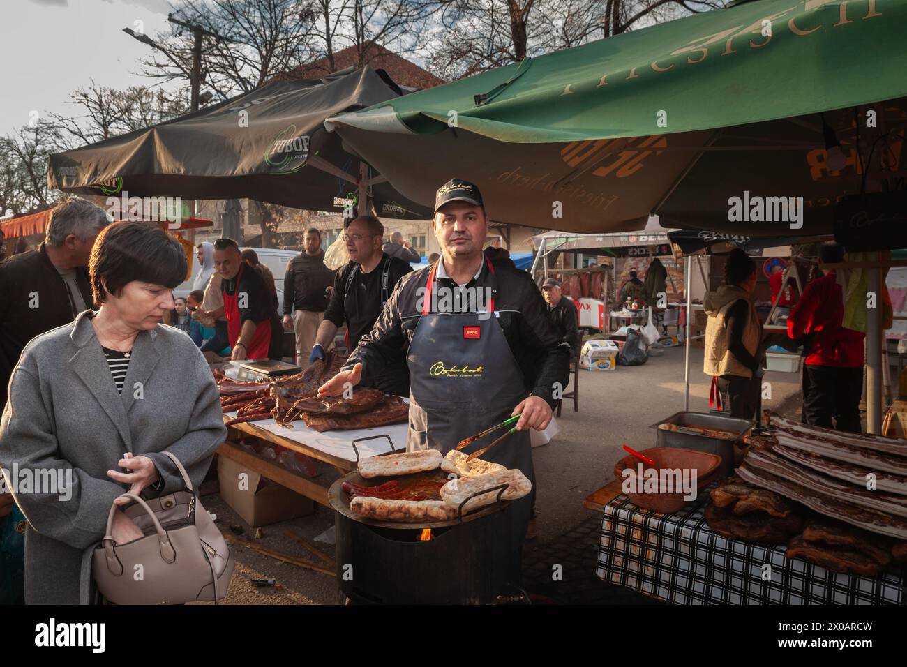 Picture of sausages, serbian sausages, cooking being handled by a ...