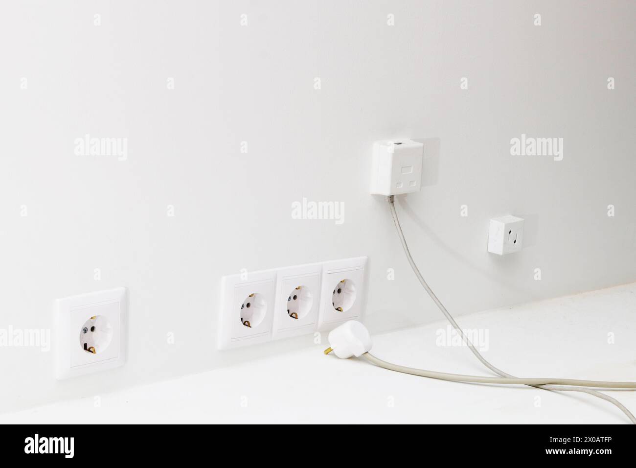 A power cord cable is disconnected from a group of white European ...