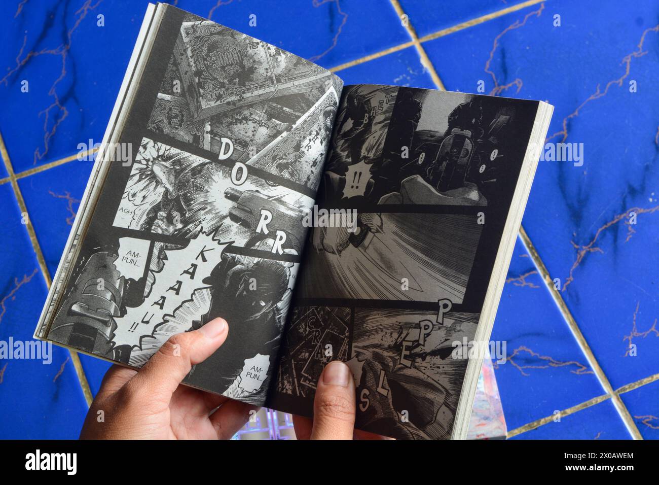 May 29, 2023. Woman reading comic on the porch of the house. Wonosobo ...