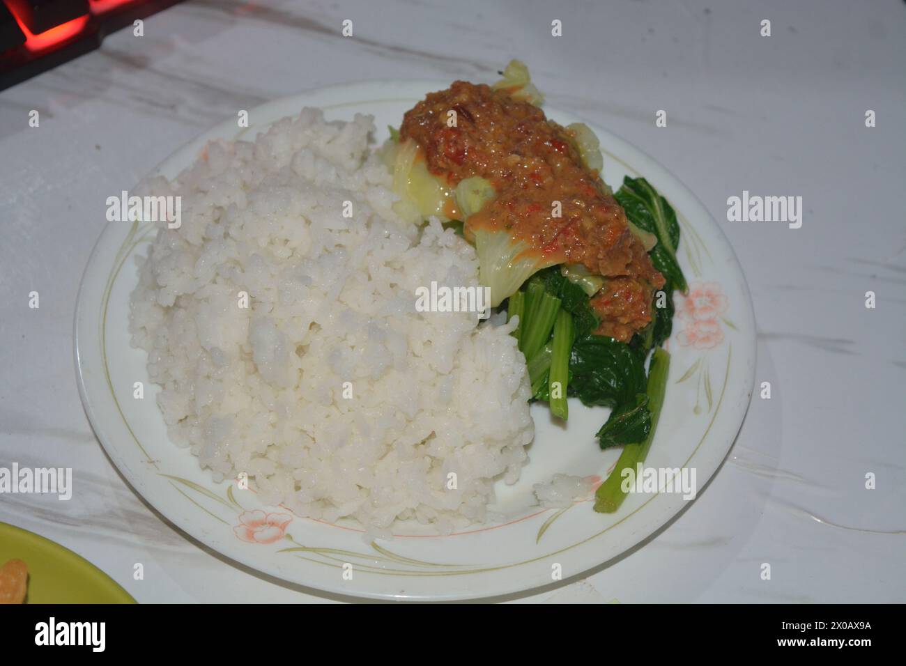 A plate of pecel rice, on a white background Stock Photo - Alamy