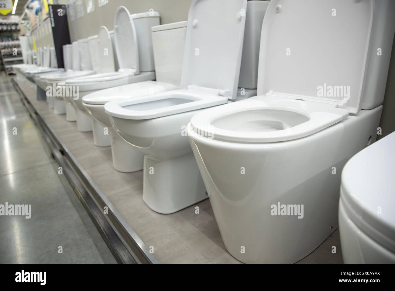 Toilet bowls in a home goods store. New modern toilet in the plumbing ...