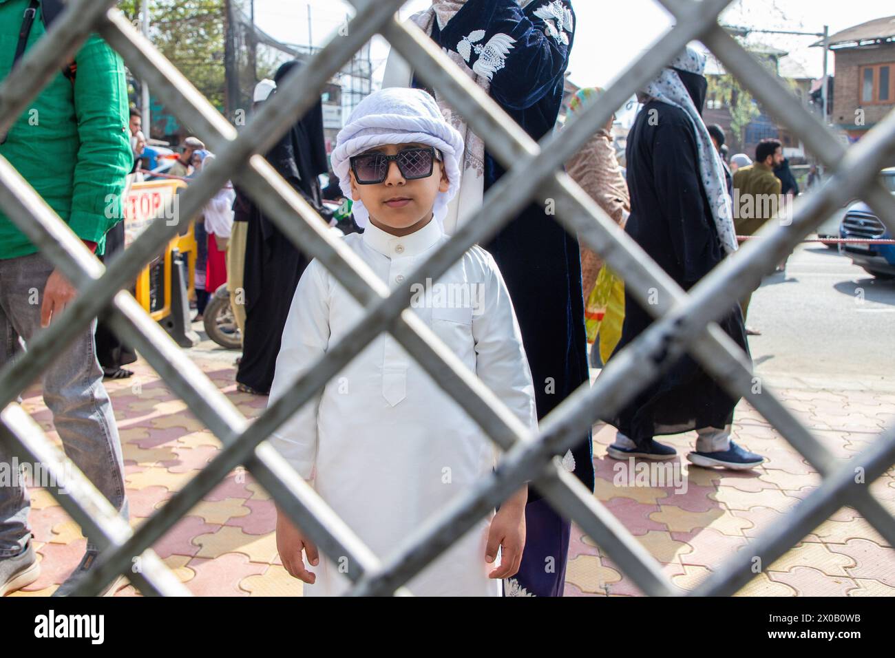 Srinagar, India. 10th Apr, 2024. A Kashmiri boy poses for a photo after ...