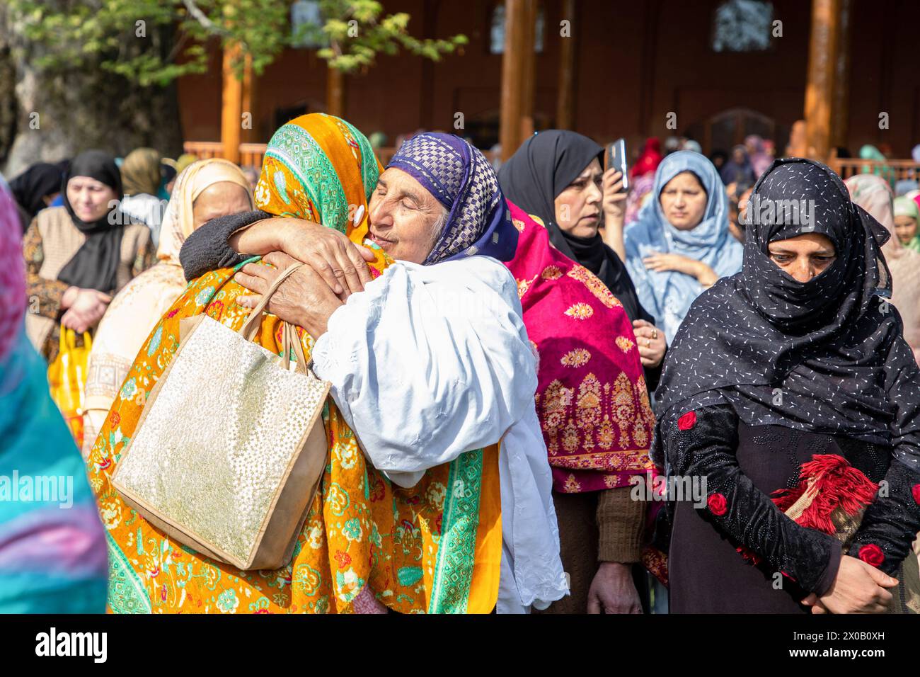 Srinagar, India. 10th Apr, 2024. Kashmiri women greet each other after offering Eid-Al-Fitr ...