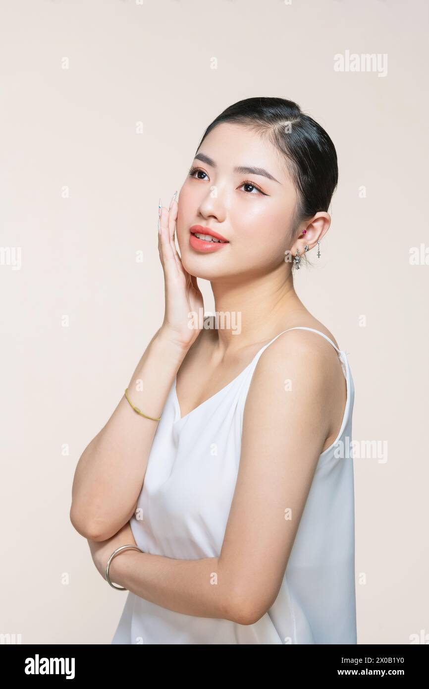 lovely girl with shiny smile touching her cheek, woman with light mua ...