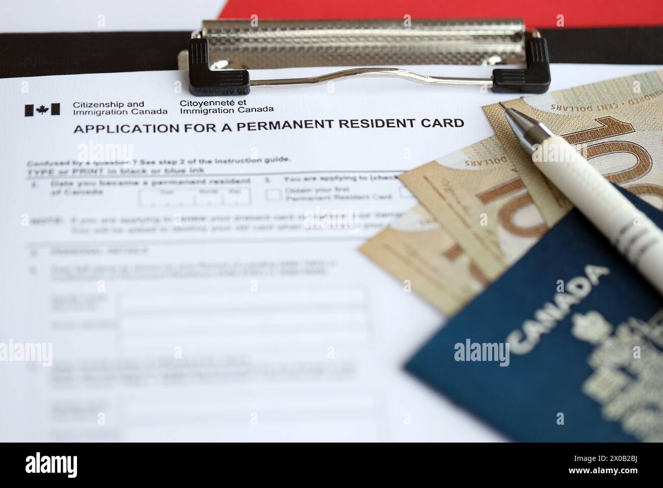 Application for permanent resident card on table with pen and canadian ...