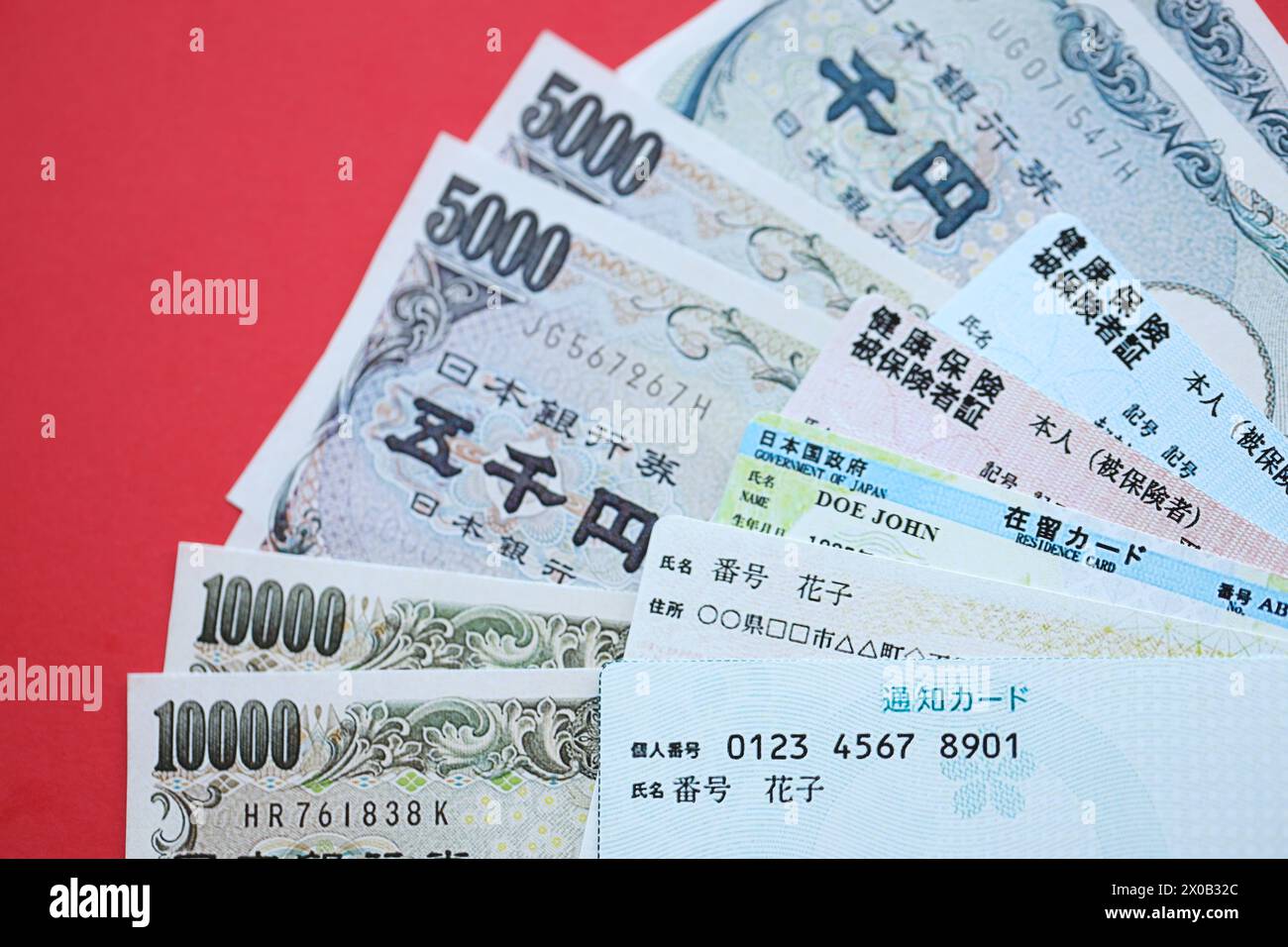Light blue and red Japan Health Insurance cards on table with japanese ...