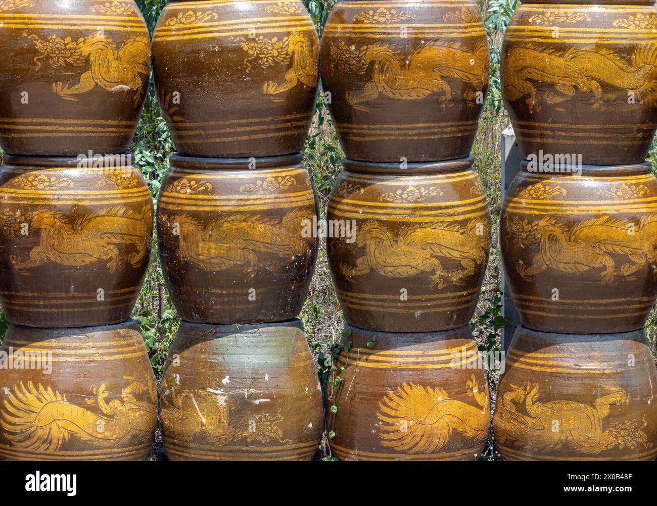 Rows of glazed water containers with a dragon pattern Stock Photo - Alamy