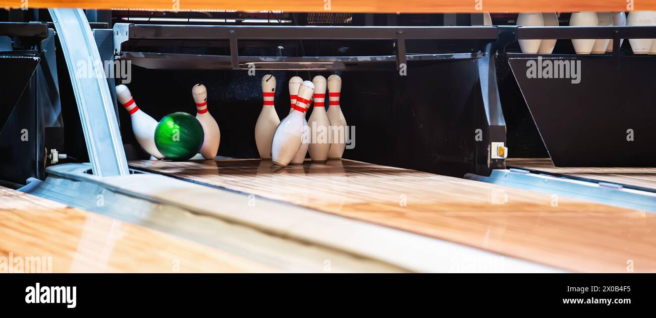 Bowling ball hits pins at end of glossy wooden bowling alley Stock ...