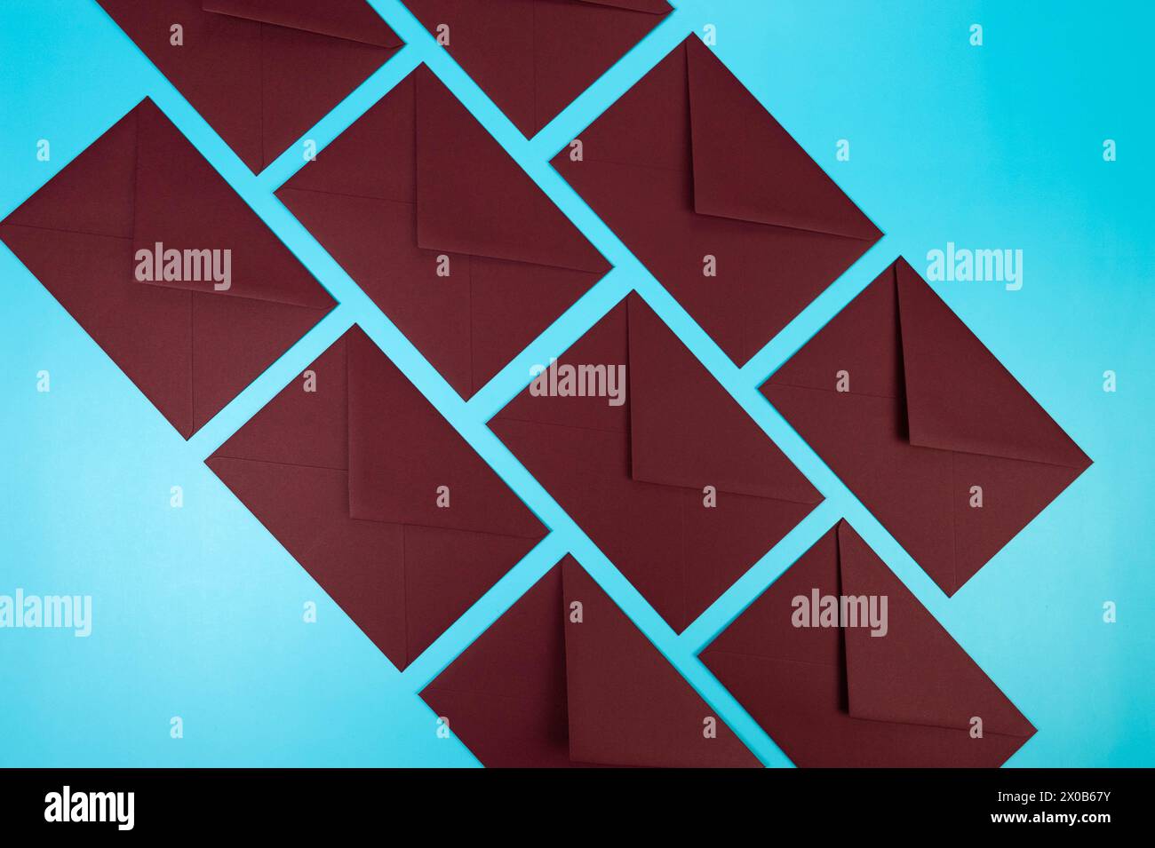 Top view of dark red envelopes on blue background. Post flat lay. Copy ...