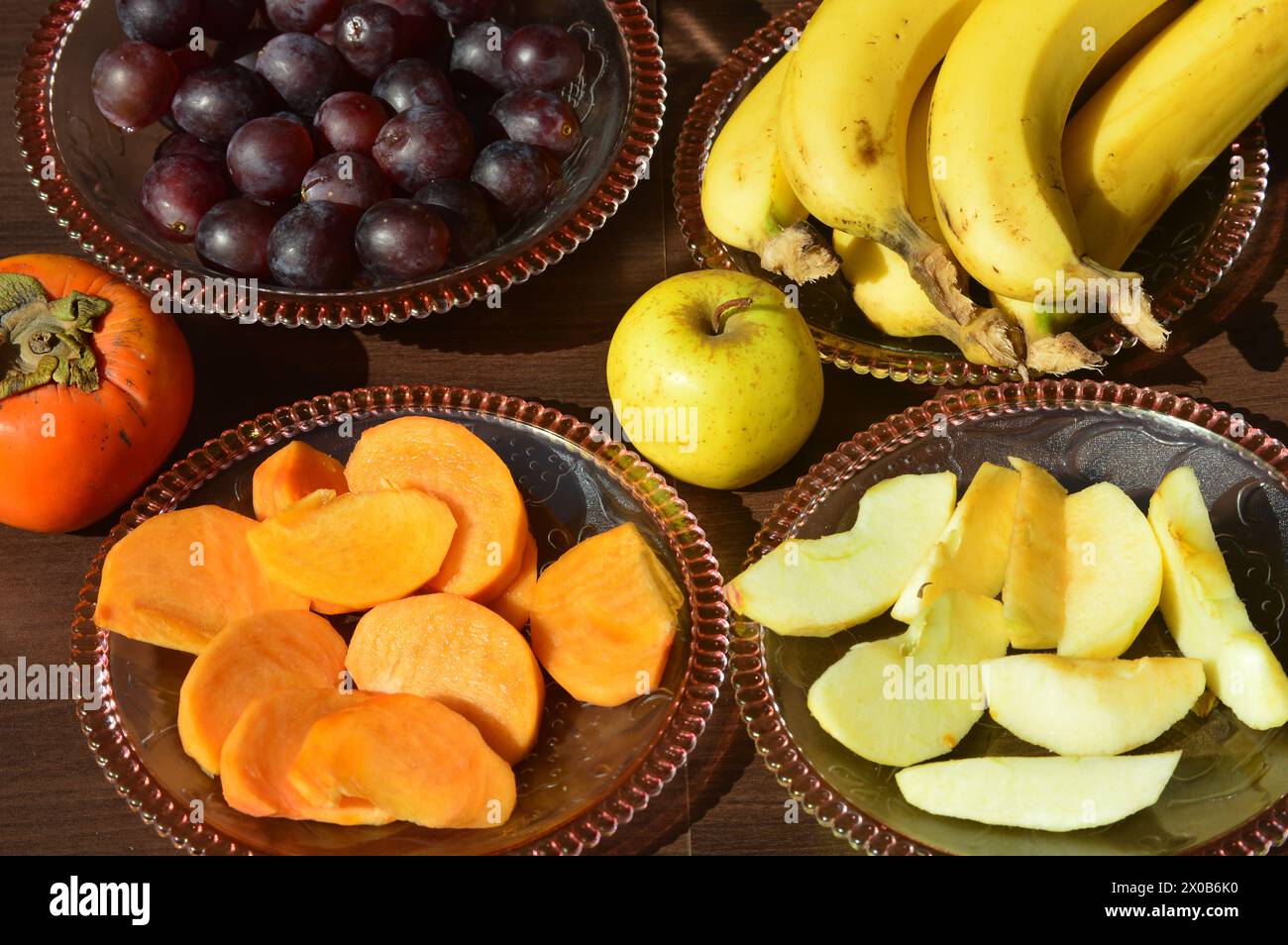 Variety of everyday fruits like banana apple grapes and persimmon good ...
