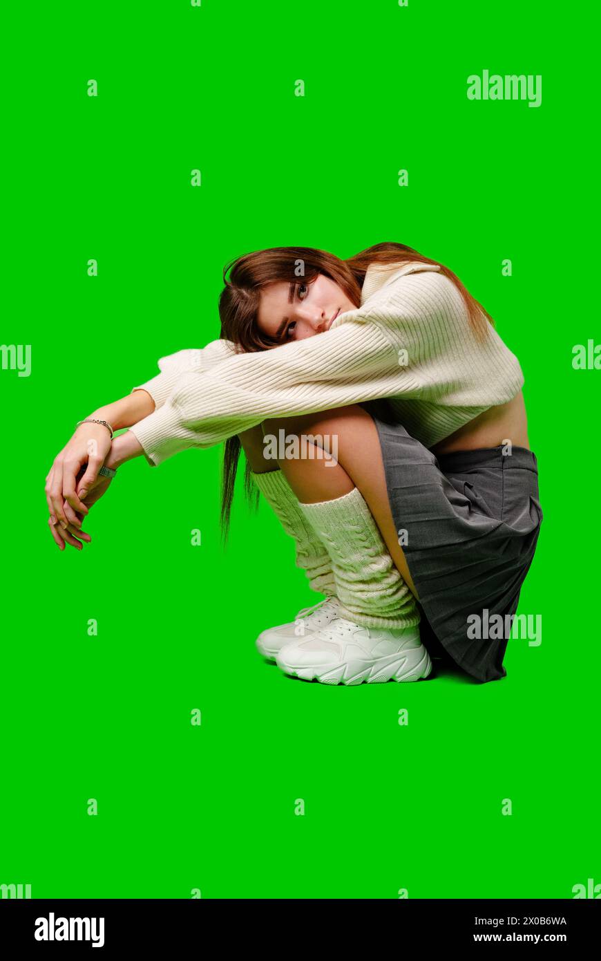 Woman Sitting on Ground in Front of Green Screen Stock Photo - Alamy
