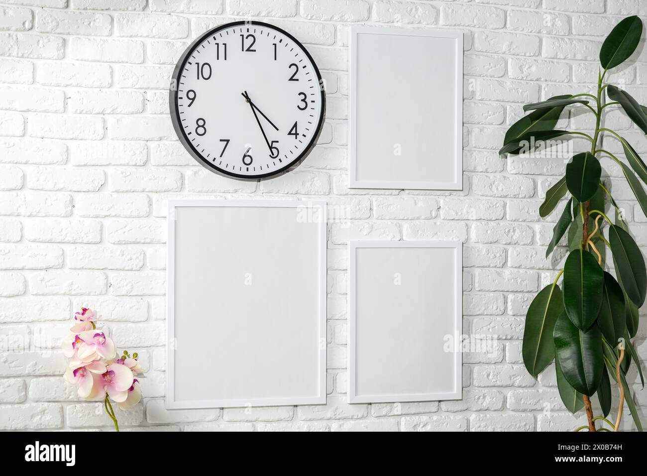 Minimalist White Wall Display With Clock and Empty Frames in a Modern ...