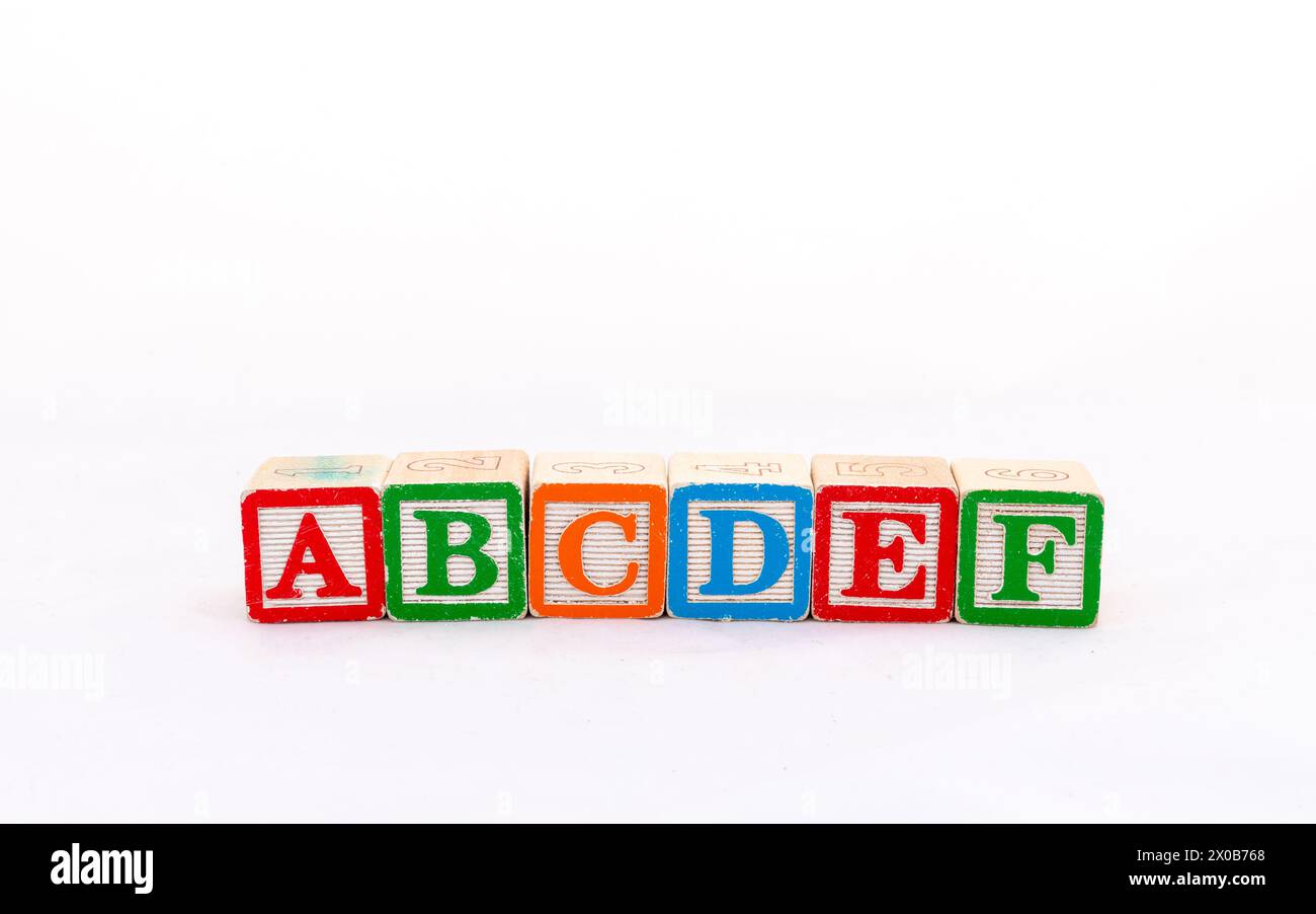 Closeup wooden letter toy arranged the word ABCDEF in a row isolated on ...