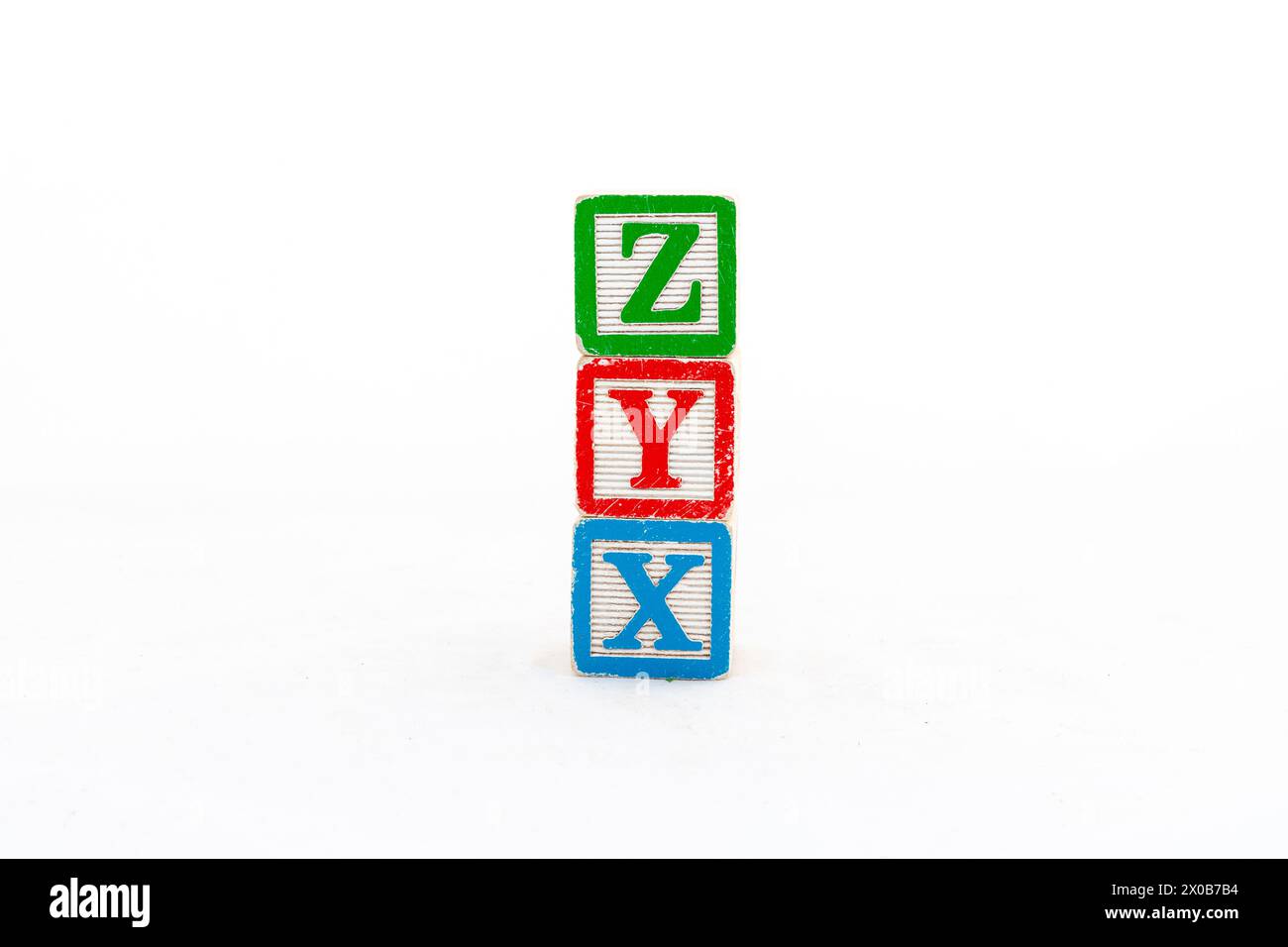 Wooden blocks Z, Y and X stacked vertically isolated on white ...