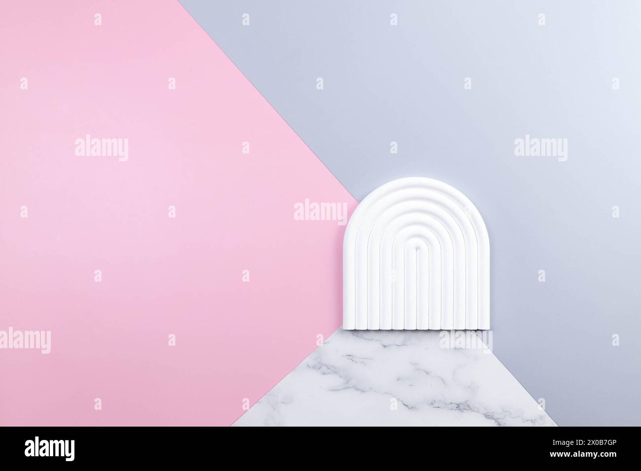 Top view of white arch tray on colourful background. Blue, pink and ...