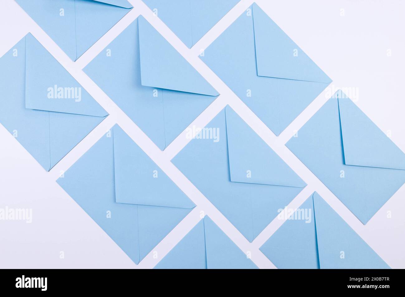 Top view of light blue envelopes on white background. Post flat lay ...