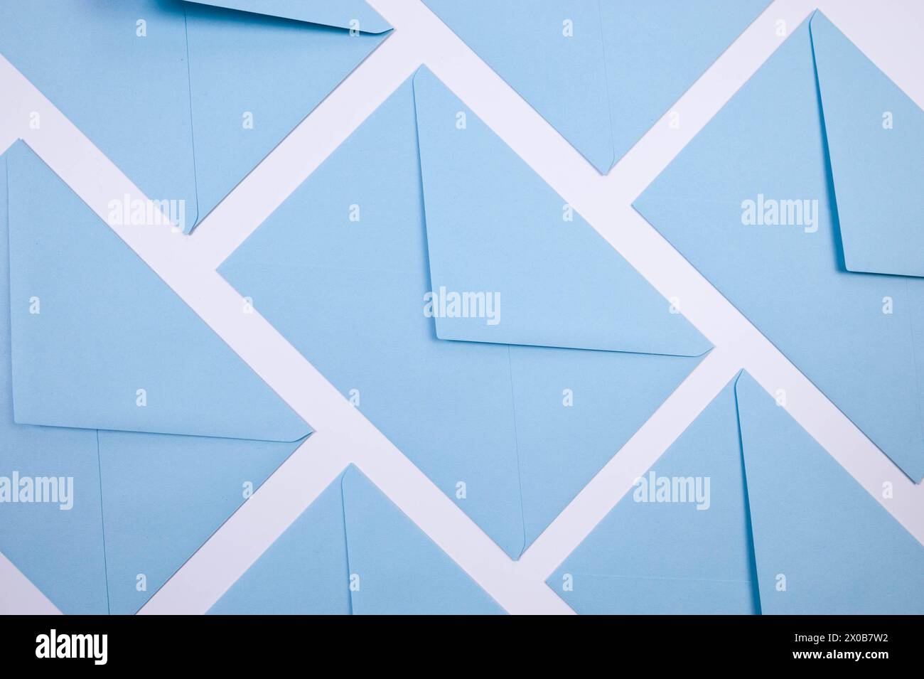 Top view of light blue envelopes on white background. Post flat lay ...
