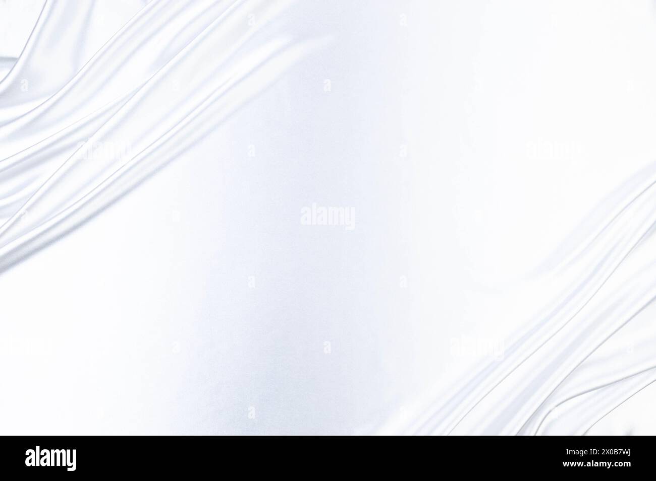 Luxury white satin background. Soft and elegant silk fabric. Flowing waves textile. Top view ...