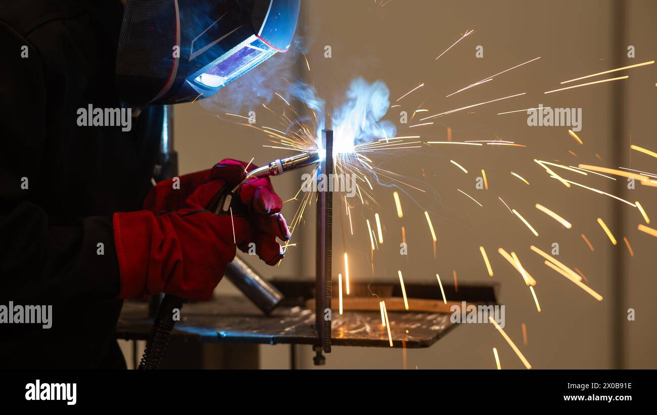 A man learns the craft of welding on a sample Stock Photo - Alamy