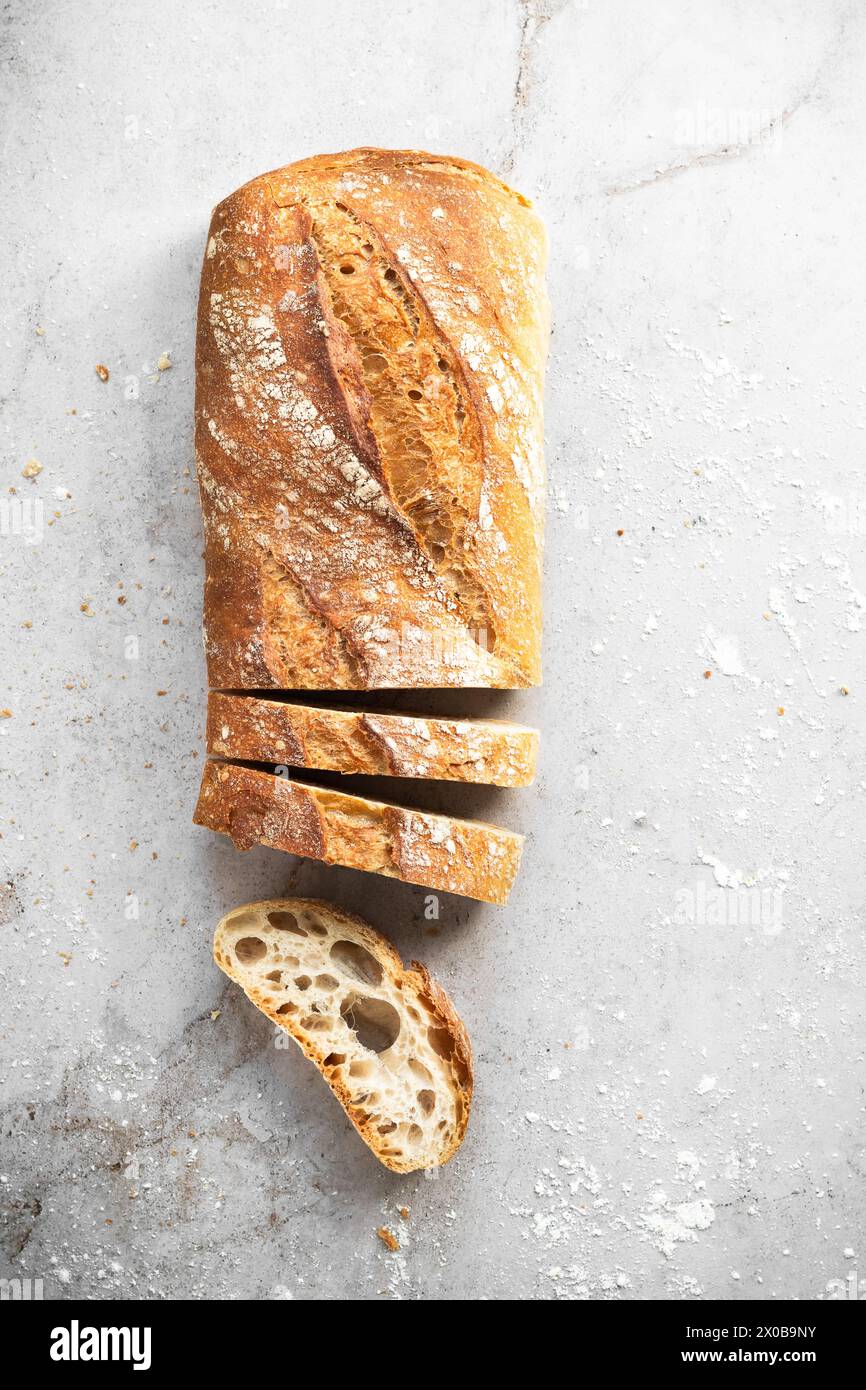 Sliced bread isolated on a stone background. Cuts of bread and crumbs ...