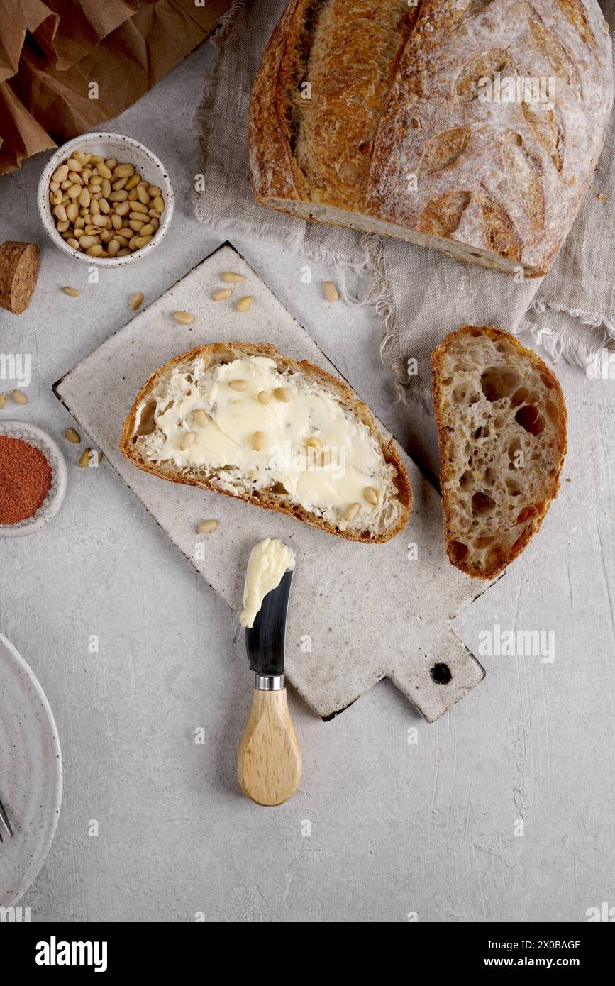 Artisan sliced toast bread with butter on cutting board. Simple ...