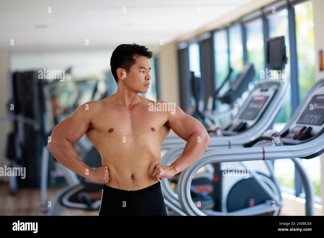 Man exercising in gym. Asian bodybuilder lifting weights. Sport and ...
