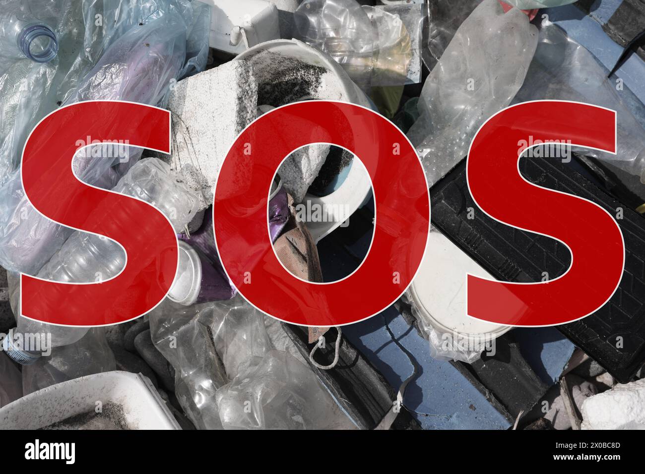 Word SOS and pile of garbage as background, top view. Environmental ...