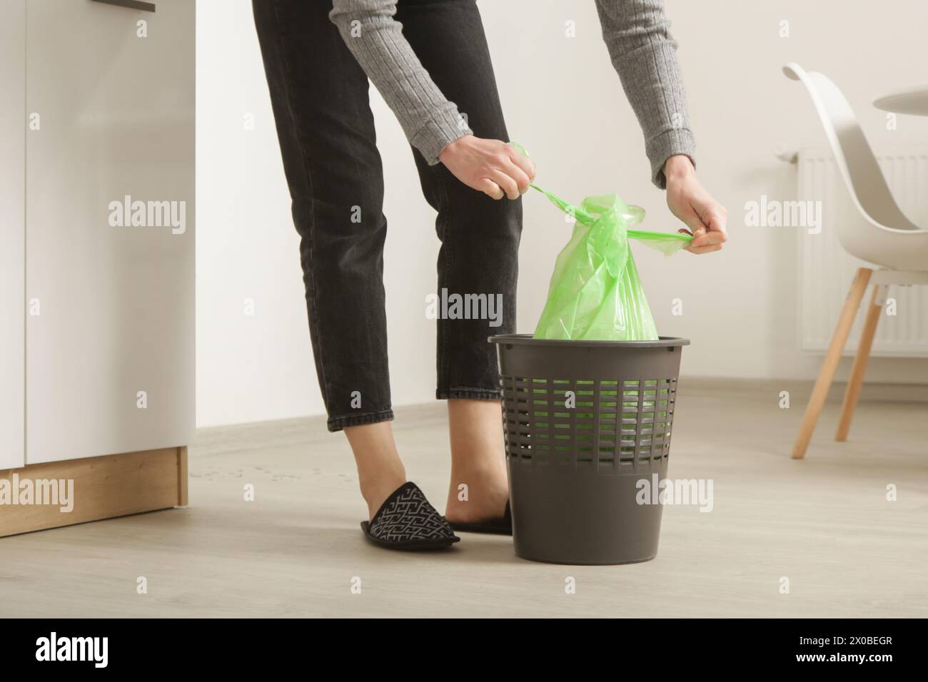 Housewife throwing away garbage, taking of plastic garbage bag from the ...