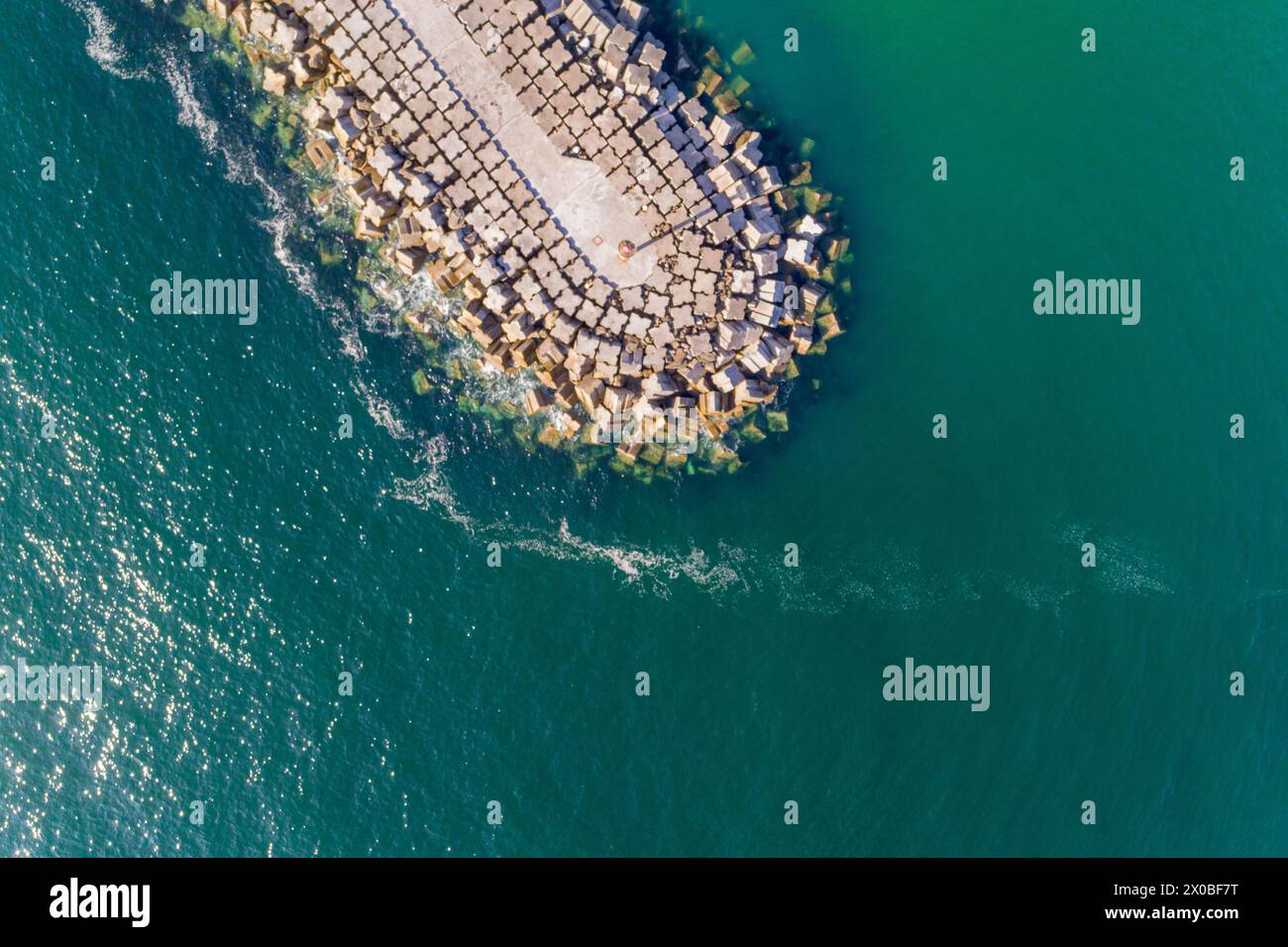 photo of a breakwater at the entrance of a harbor, aerial overhead view ...