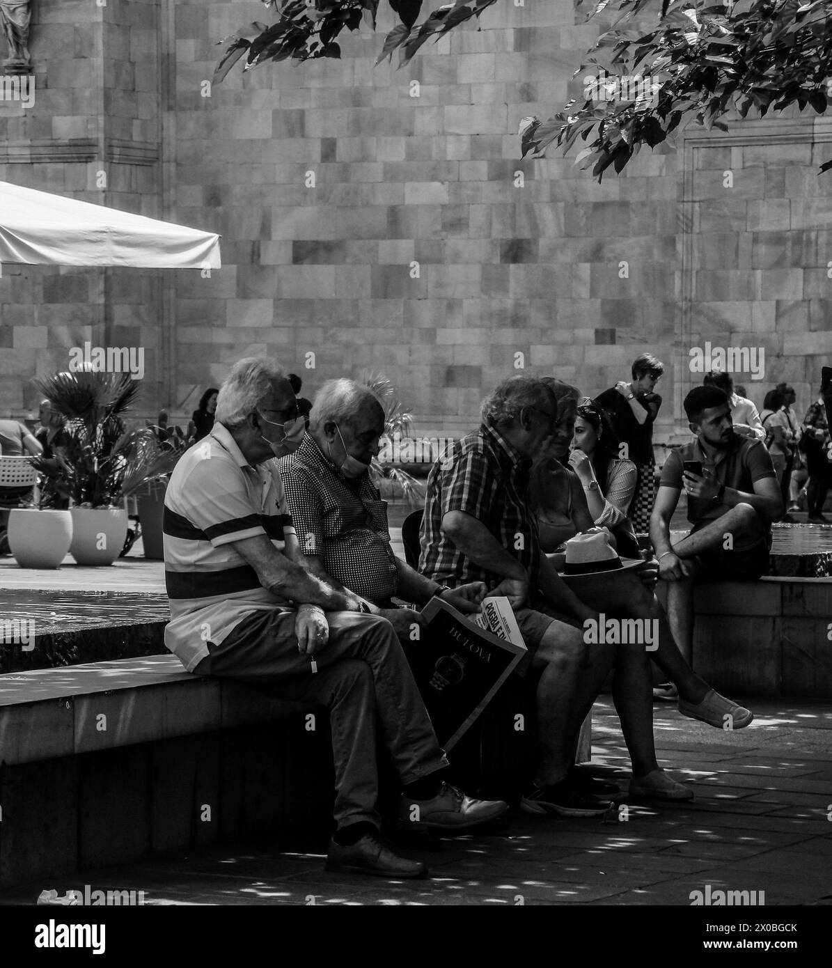 Local elderly people enjoying sunny days in a small Sicilian town ...