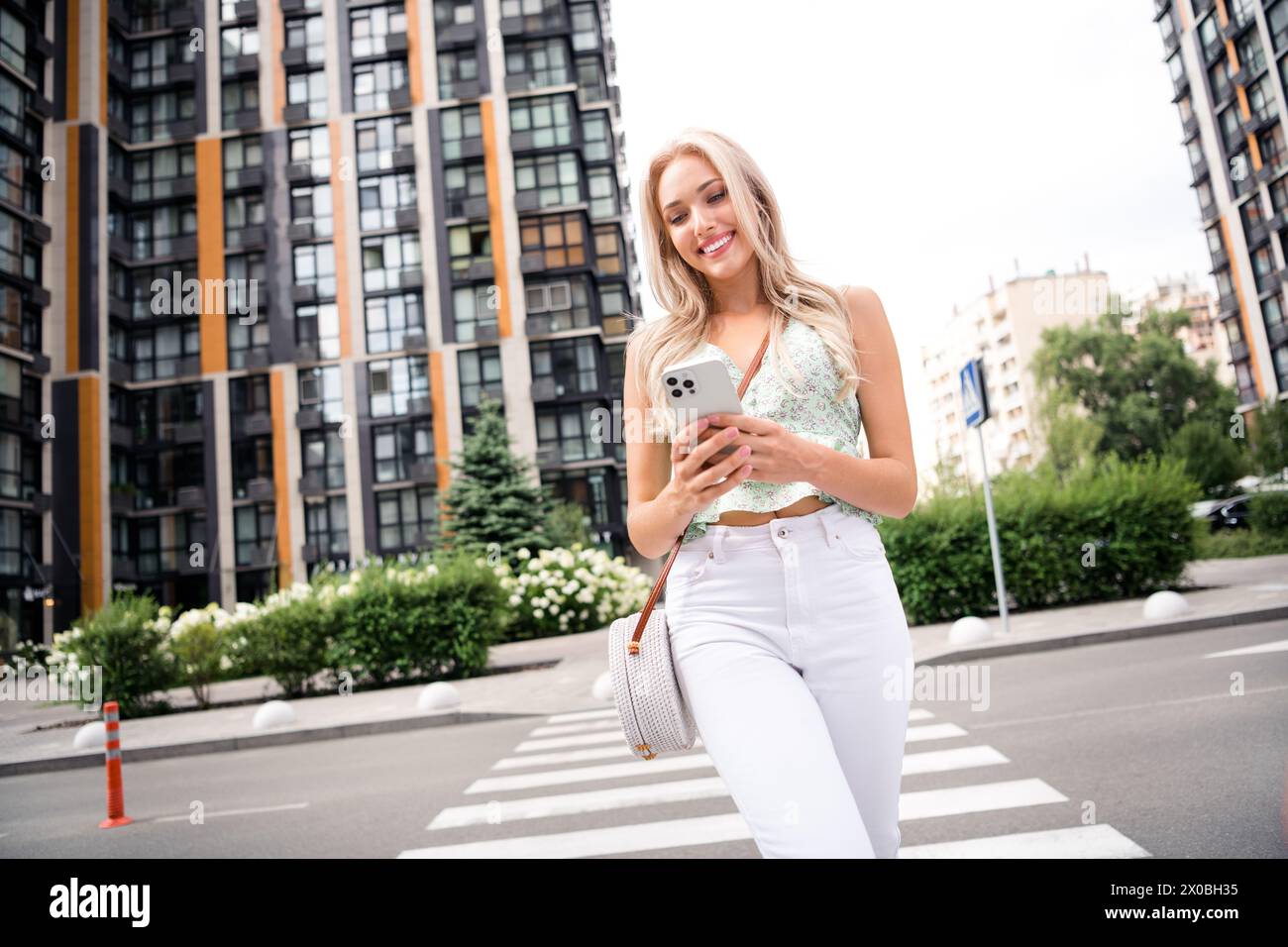 Photo of lovely positive adorable woman walking crosswalk reading ...