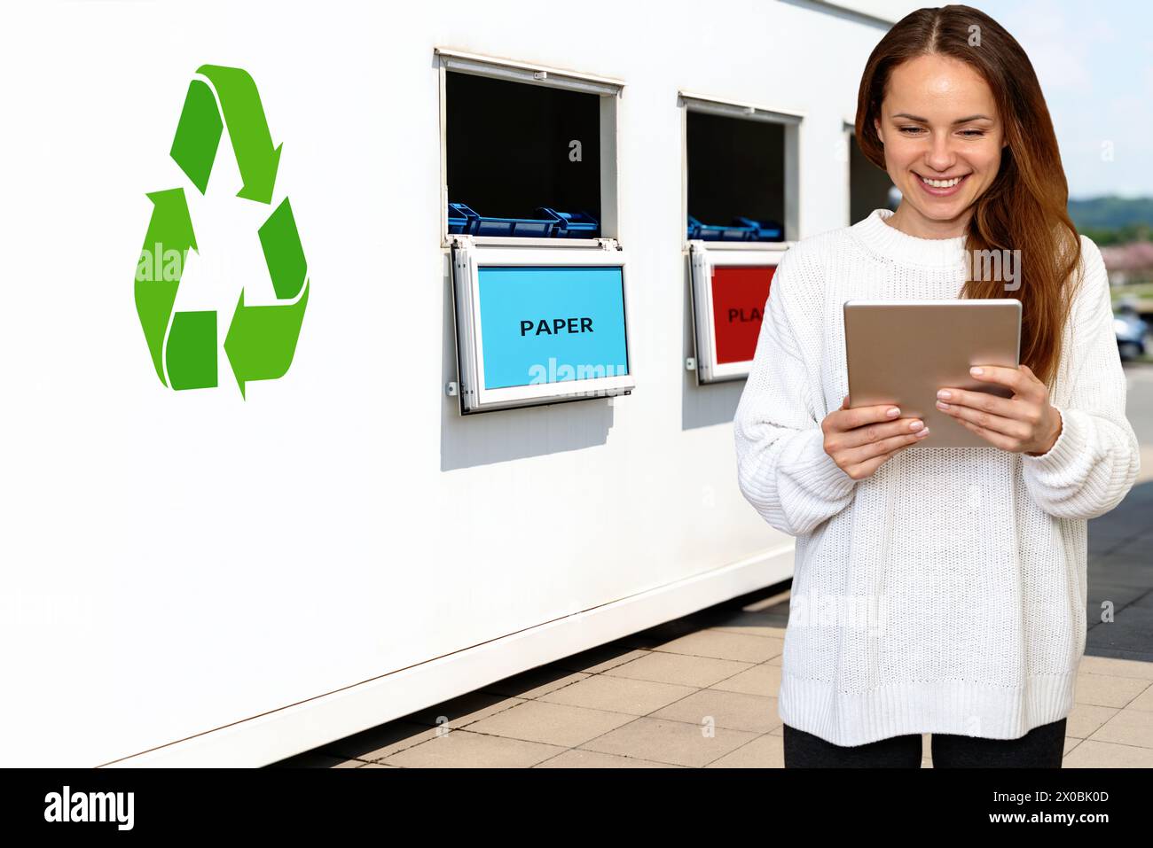 Woman uses her digital tablet while standing next to a separate waste ...