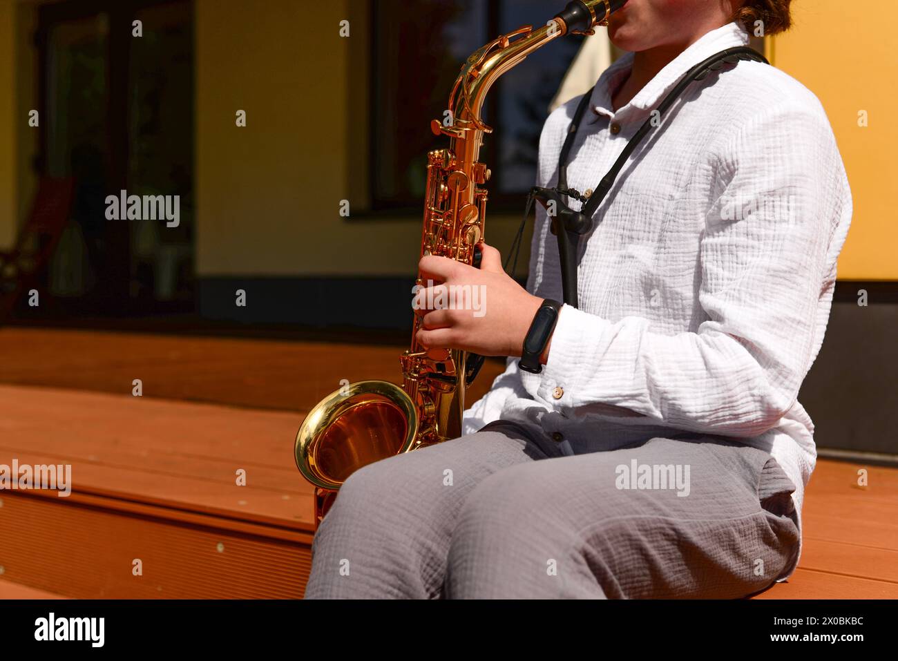 Boy playing a saxophone hi-res stock photography and images - Alamy