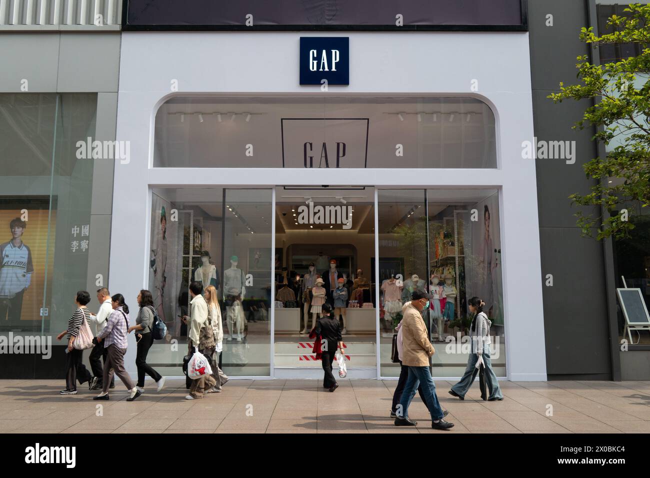SHANGHAI, CHINA - APRIL 11, 2024 - Citizens pass a newly opened GAP ...