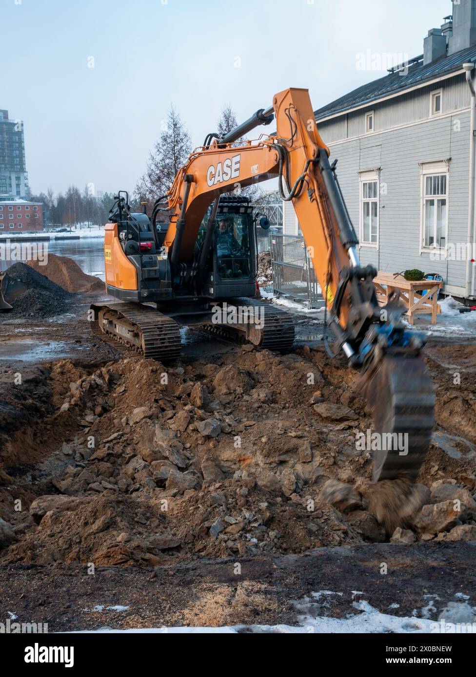 Excavator digging hole on construction site, Oulu Finland Stock Photo ...
