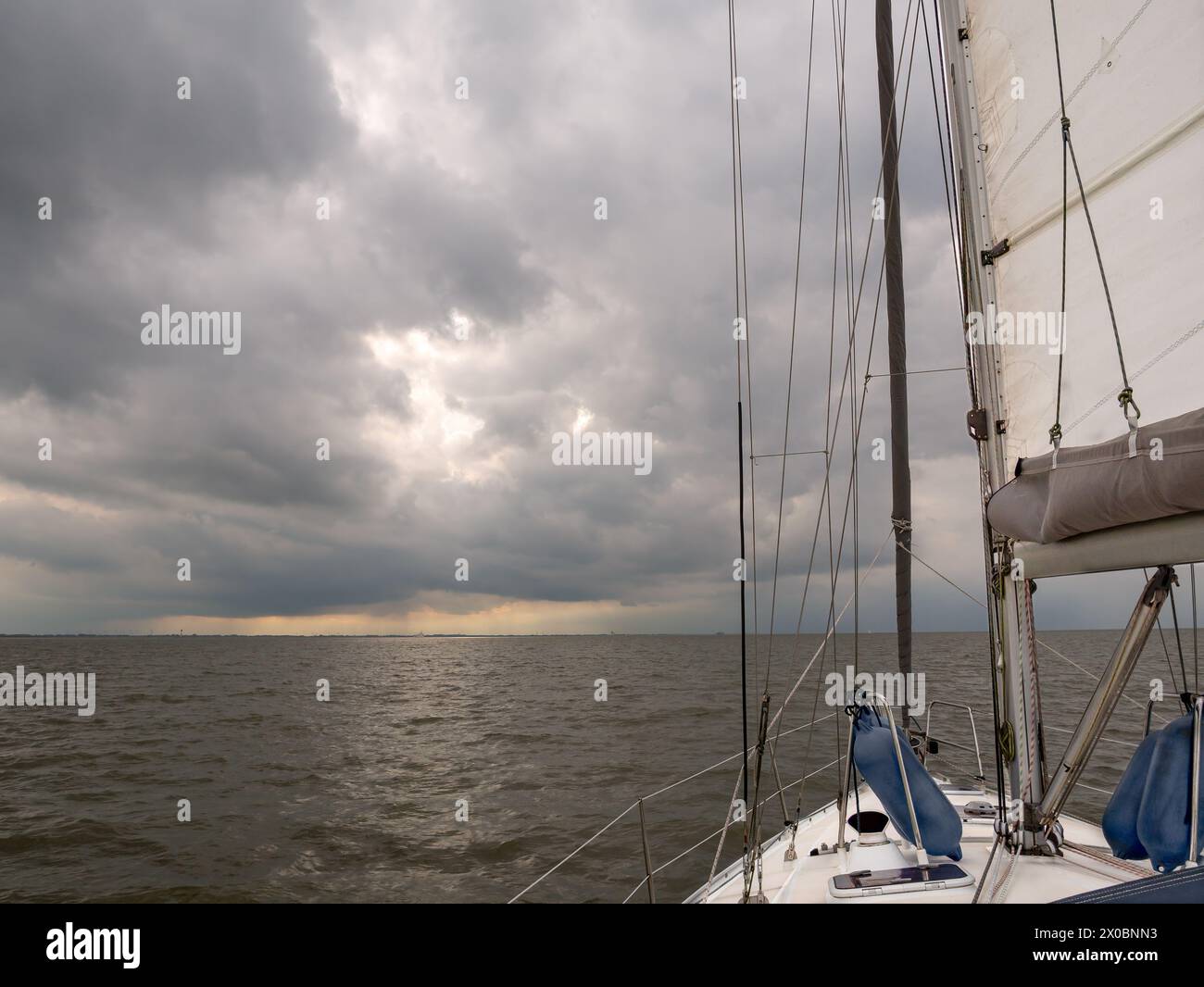 Sailboat sailing downstream on Elbe River to Cuxhaven and North Sea ...
