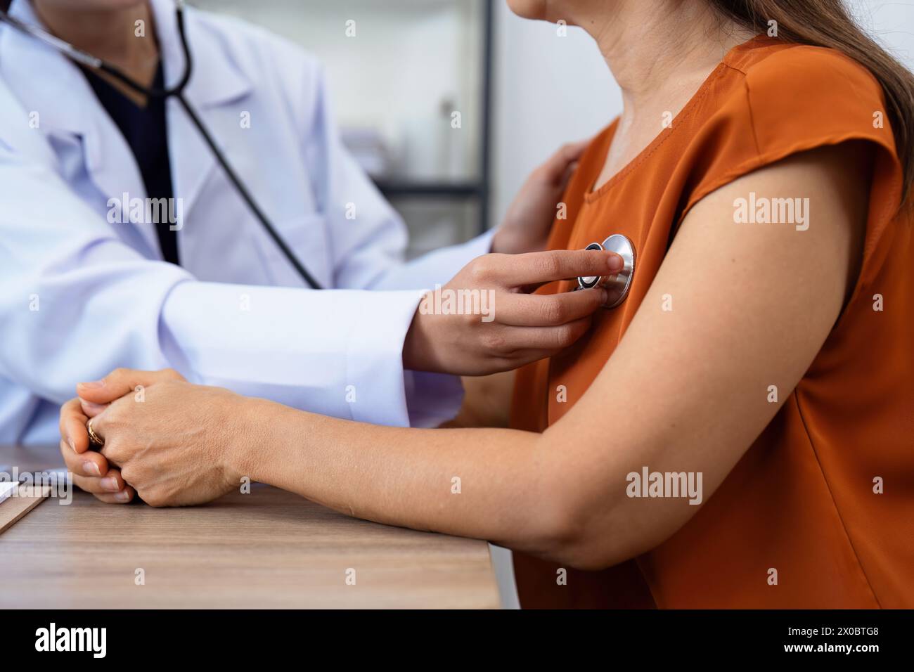 Doctor listens to heartbeat of older of retirement age to check their ...