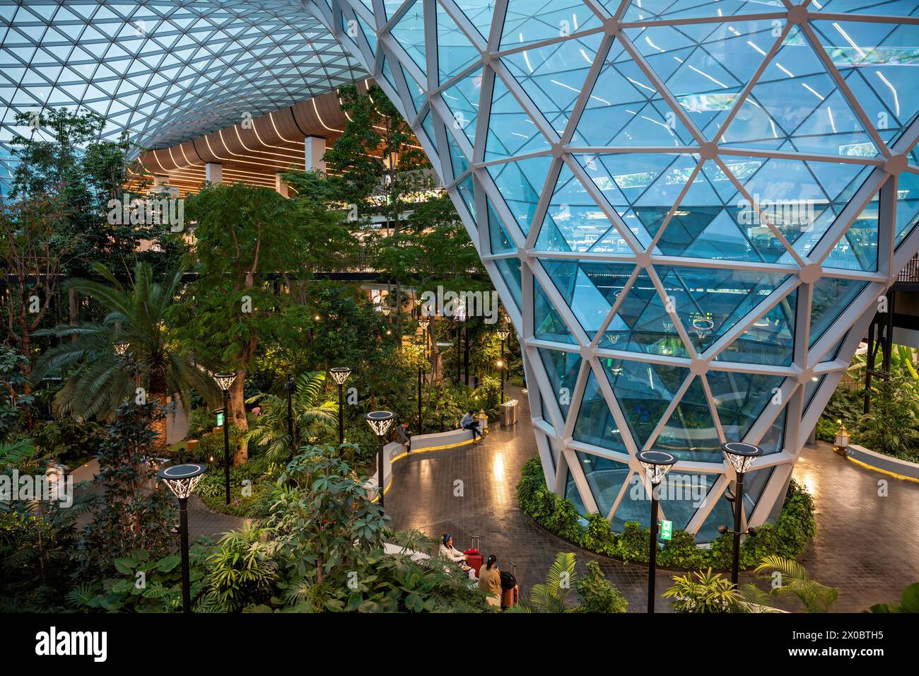 Massive glass dome and elevated walkway above indoor garden at the ...