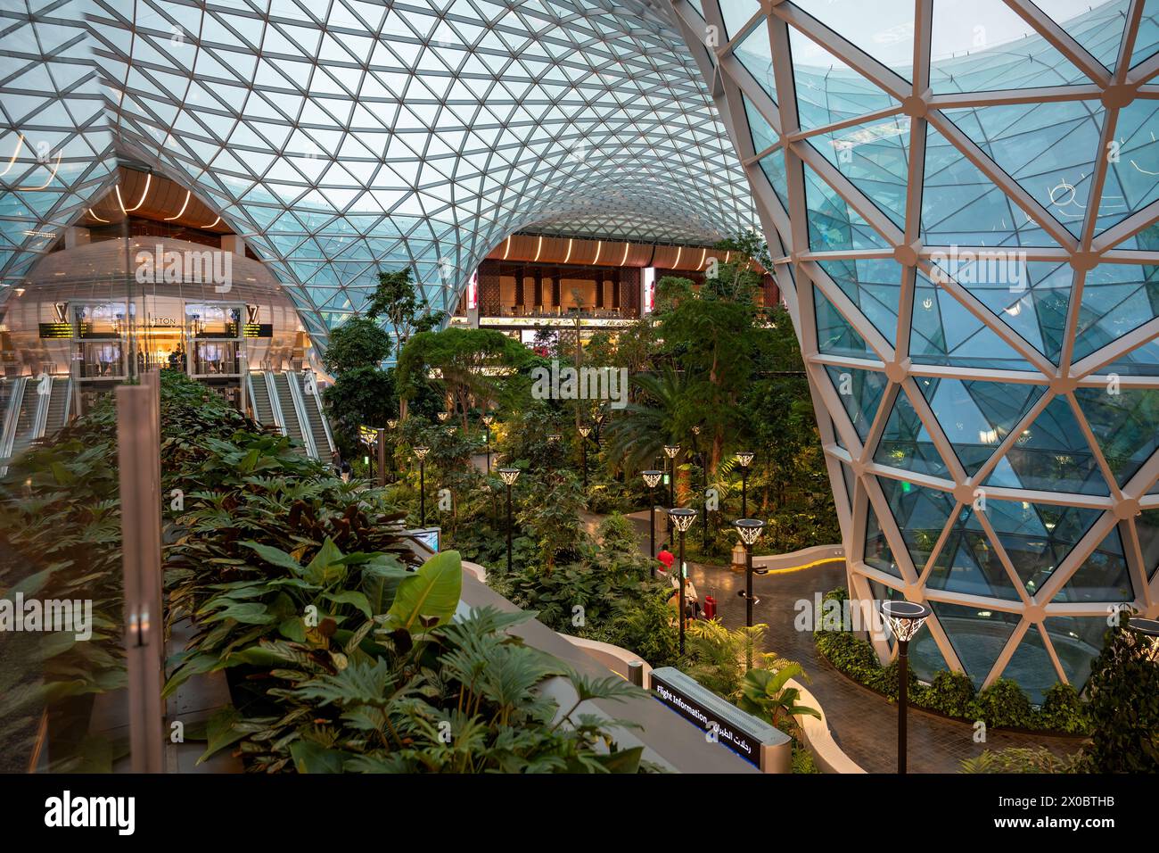 Massive glass dome and elevated walkway above indoor garden at the ...