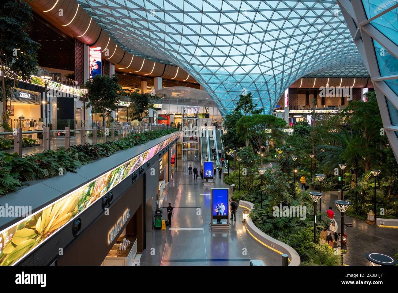 Massive glass dome and elevated walkway above indoor garden at the ...